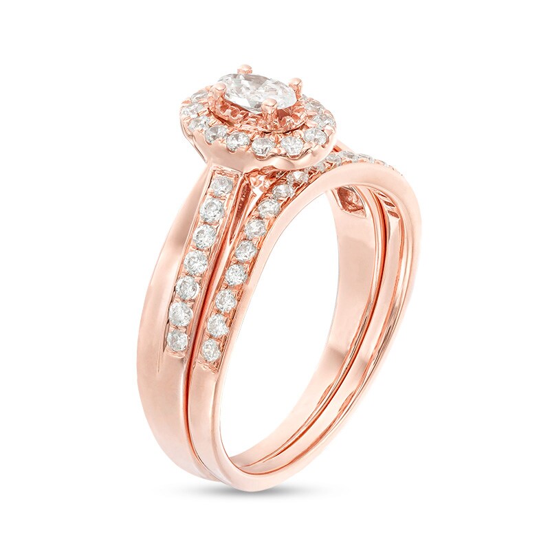 Previously Owned - 3/4 CT. T.W. Oval Diamond Frame Crossover Bridal Set ...